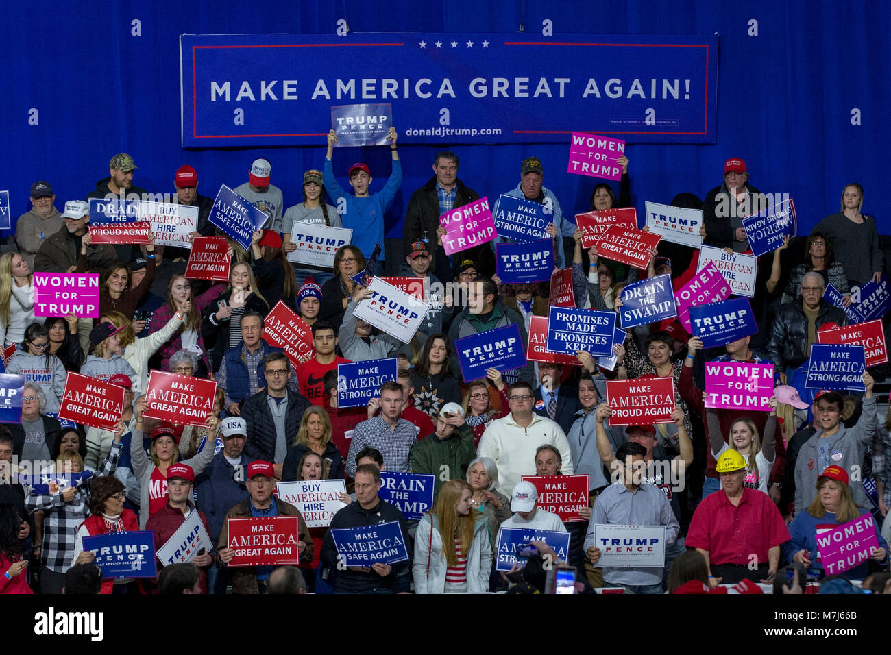 Supporters hold campaign signs during a Make American Great Rally at ...