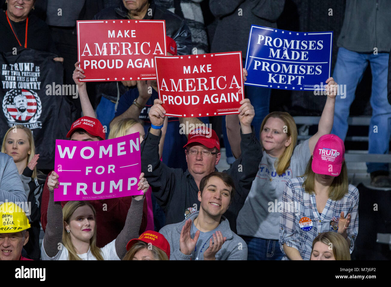 Supporters hold campaign signs during a Make America Great Again ...