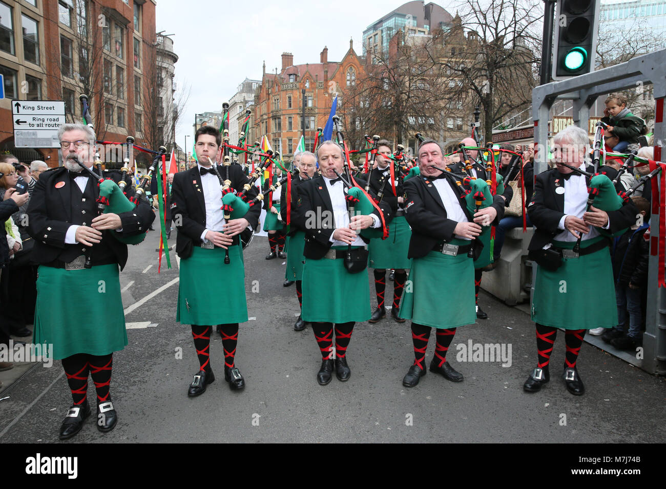 Manchester, UK. 11th March, 2018. A pipe band in Albert Square ...