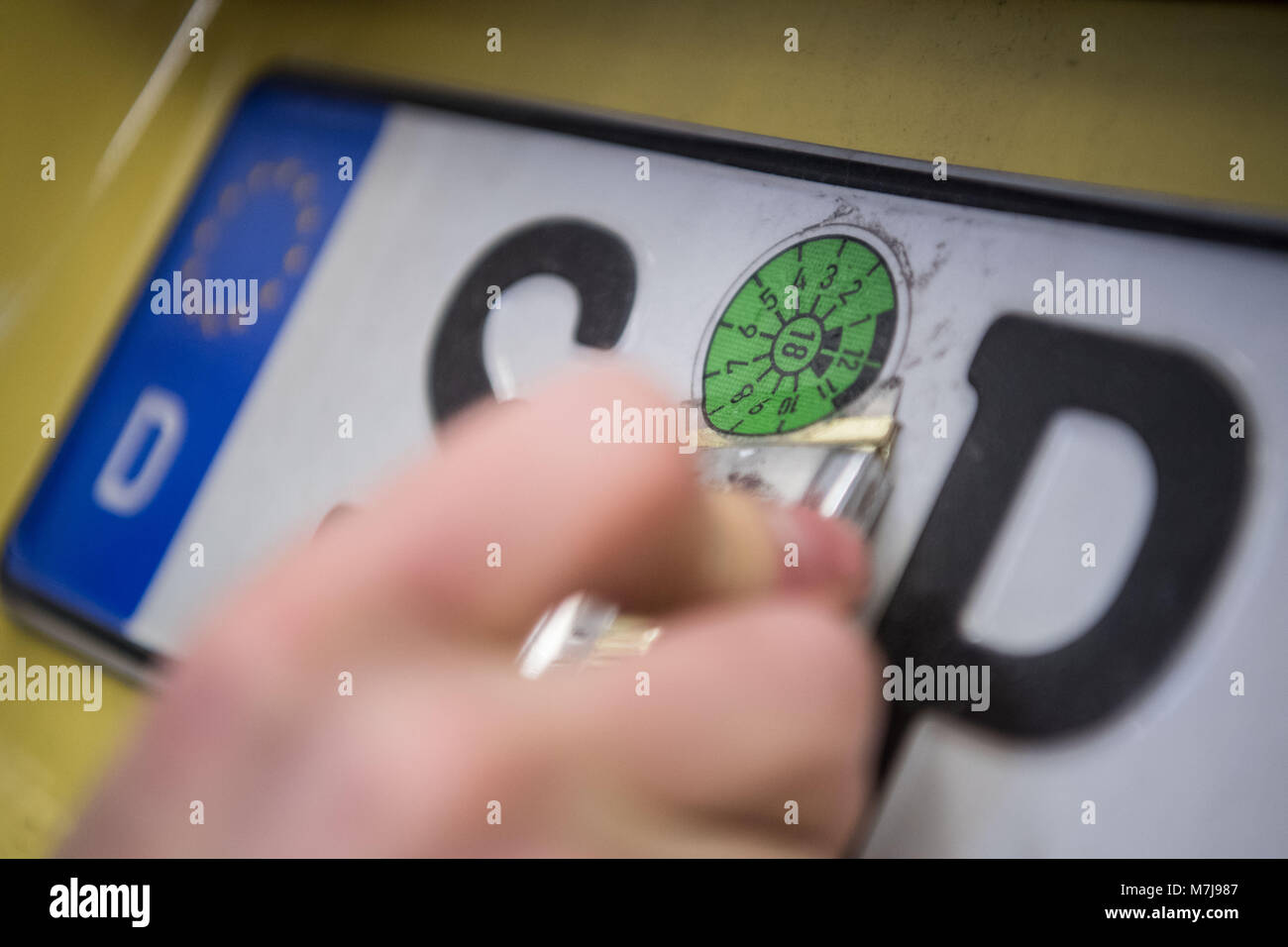 09 March 2018, Germany, Stuttgart: An employee of the vehicle ...