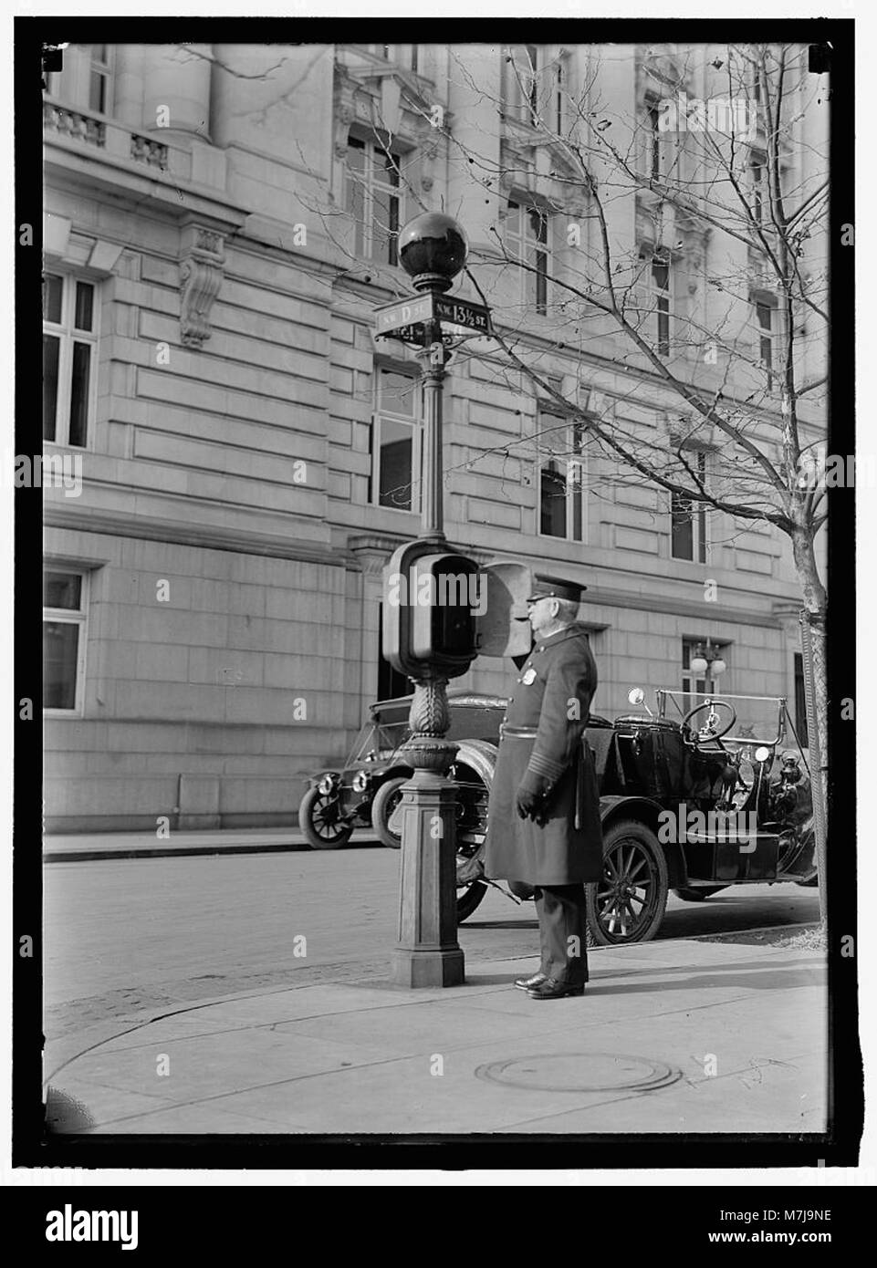 A fire alarm box and a policeman are captured in this historic image ...