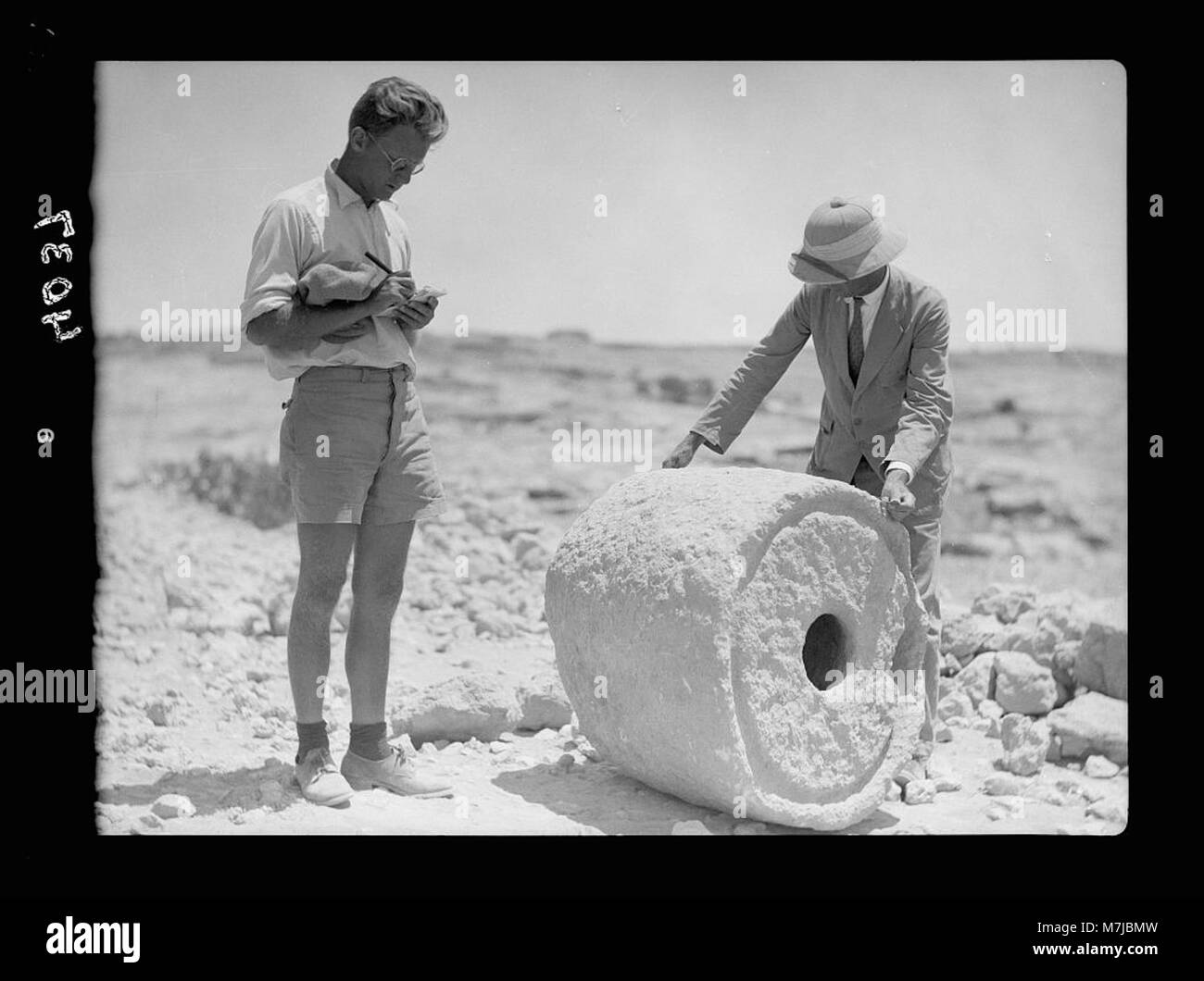 This photograph shows archaeologists excavating at Tell Beit Mirsim, an ...