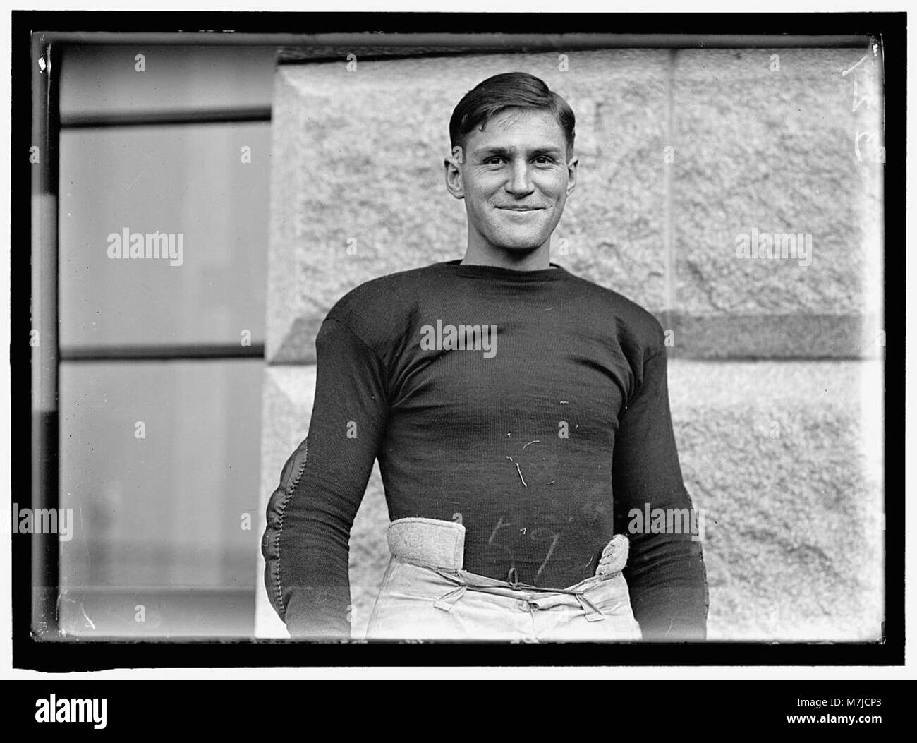 The photograph depicts the U.S. Naval Academy football team, featuring ...