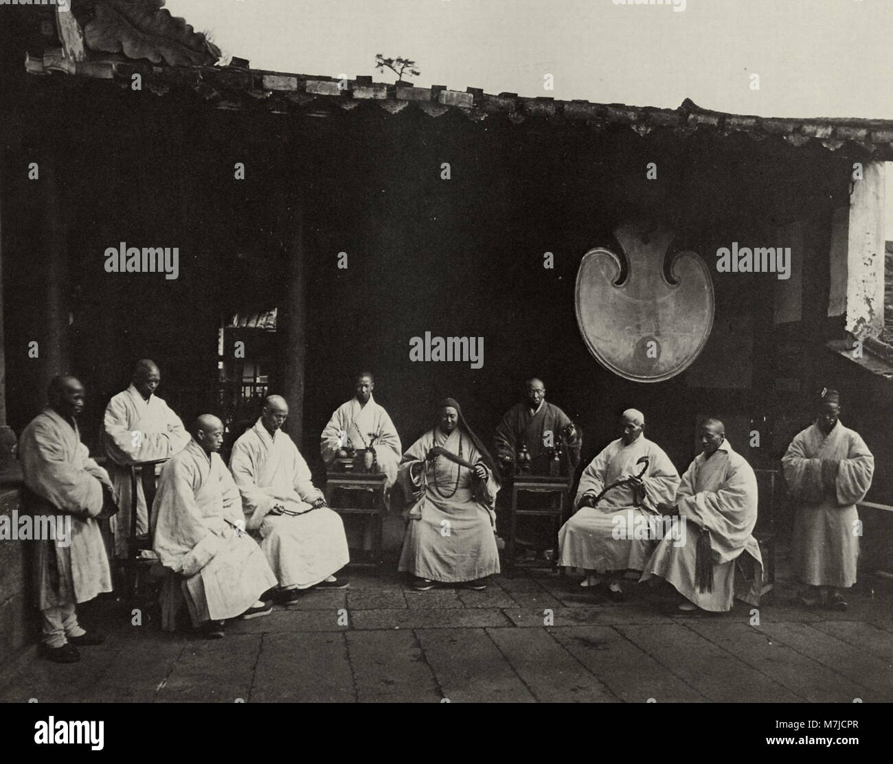 This photograph, taken by John Thomson, shows Buddhist monks at the Ku ...