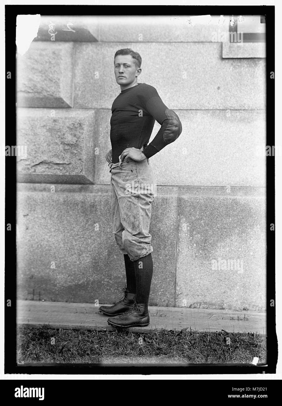 A photograph of the Naval Academy football team, including players and ...