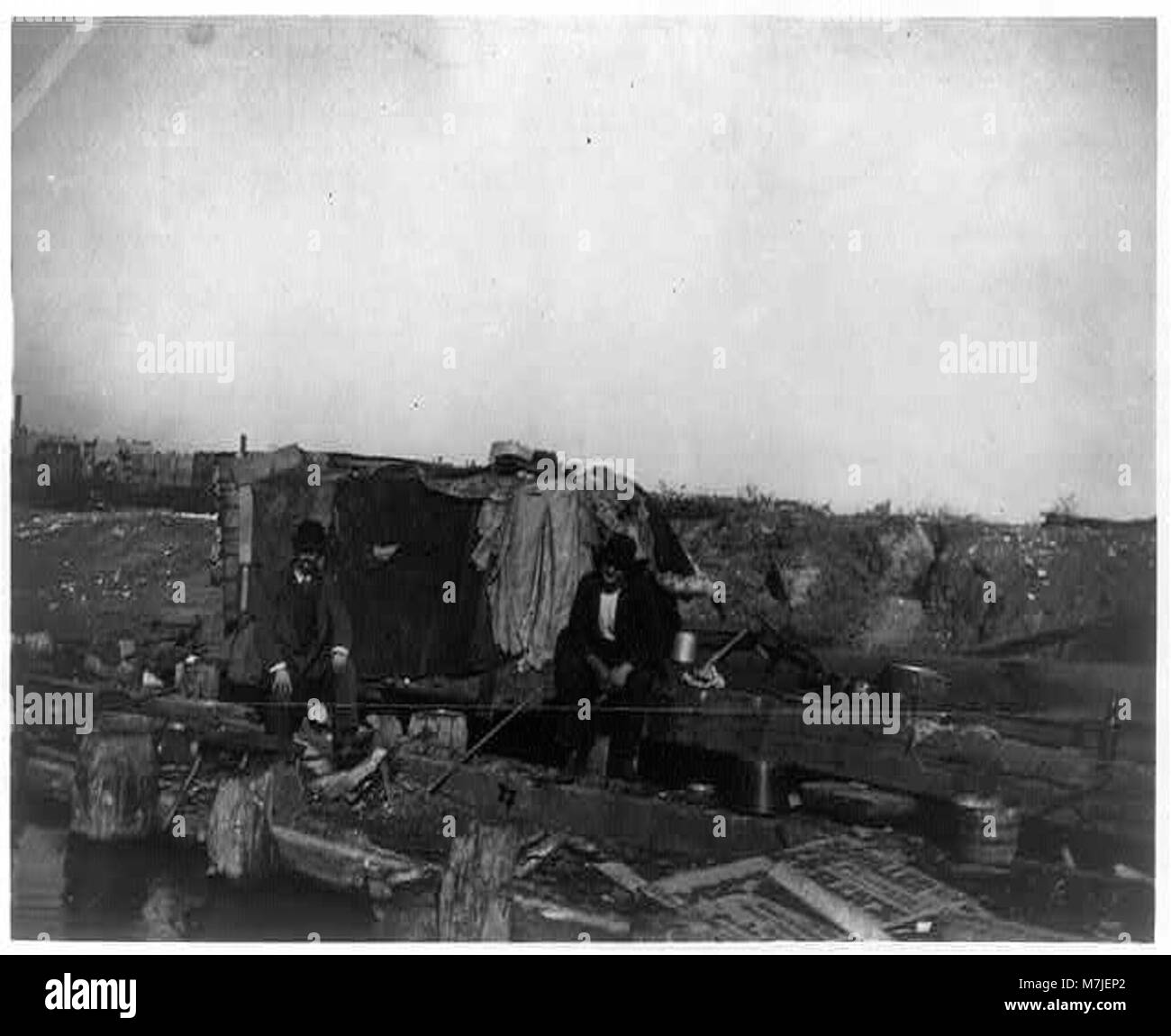 A photograph depicting two unemployed railway workers seated near a ...