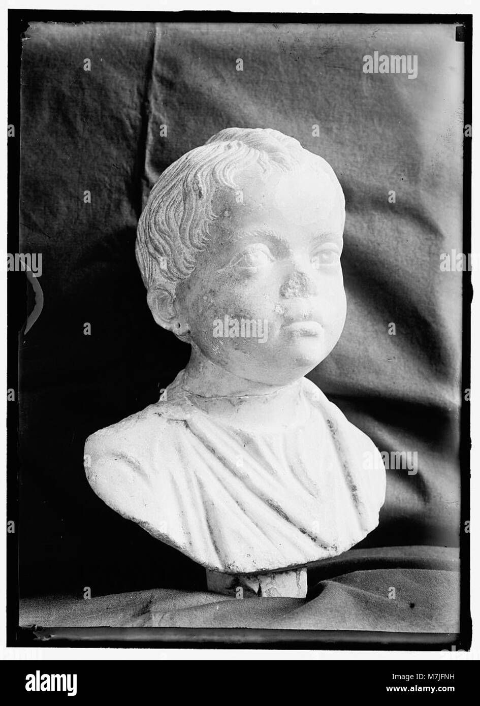 This image features a Greek statuette, a notable example of ancient ...