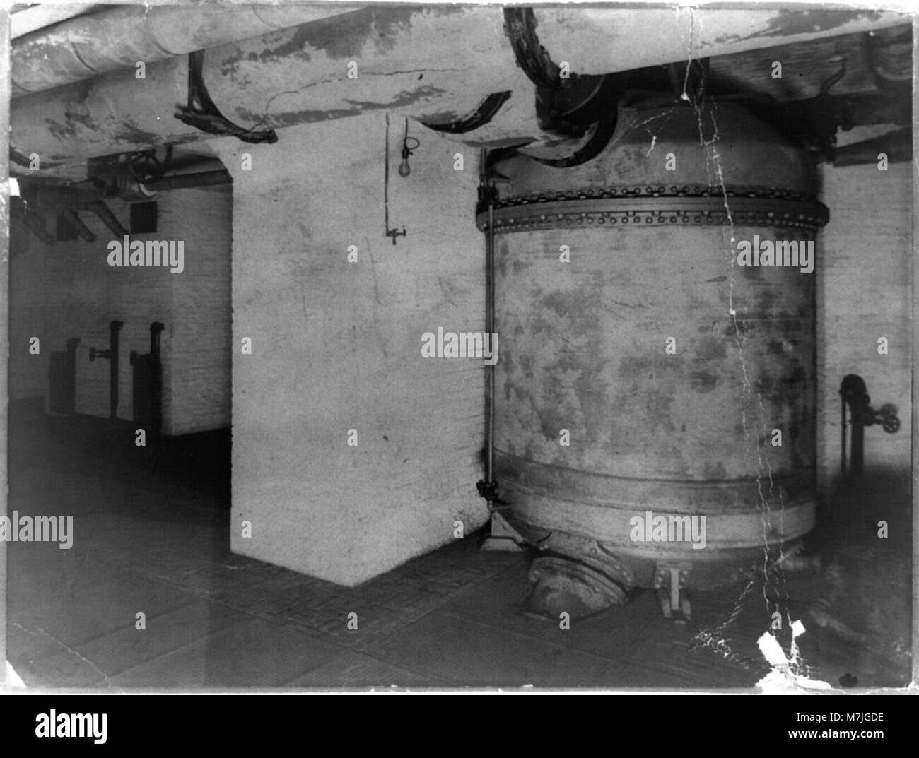 A photograph showing the interior of a basement, possibly from an early ...
