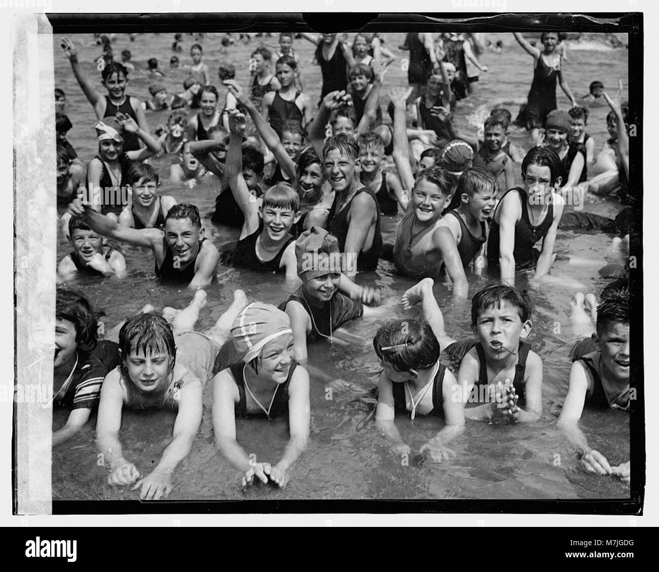 Photograph of a bathing beach scene, showcasing a day at the beach with ...