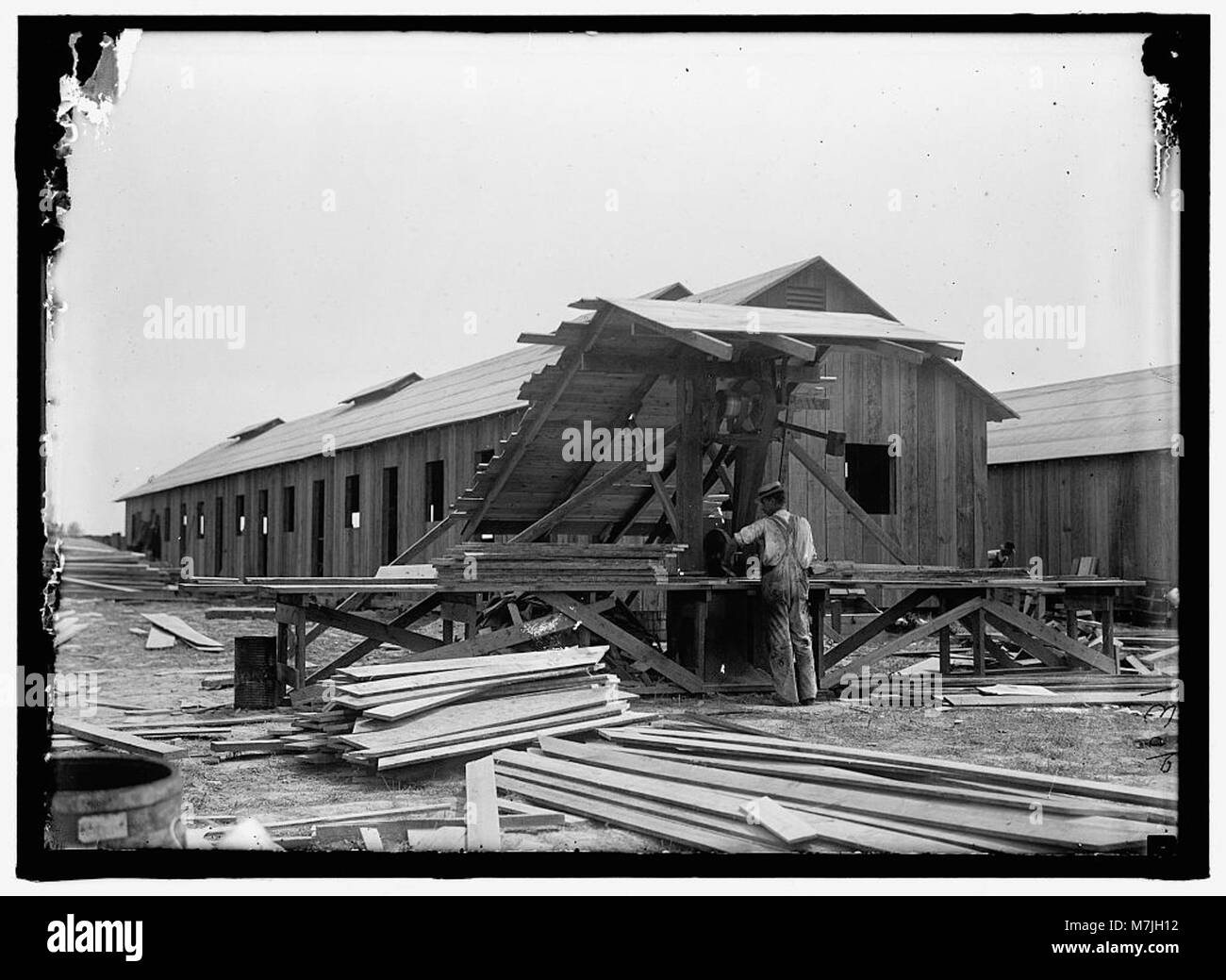 A photograph of a military camp, capturing the setup of tents, soldiers ...