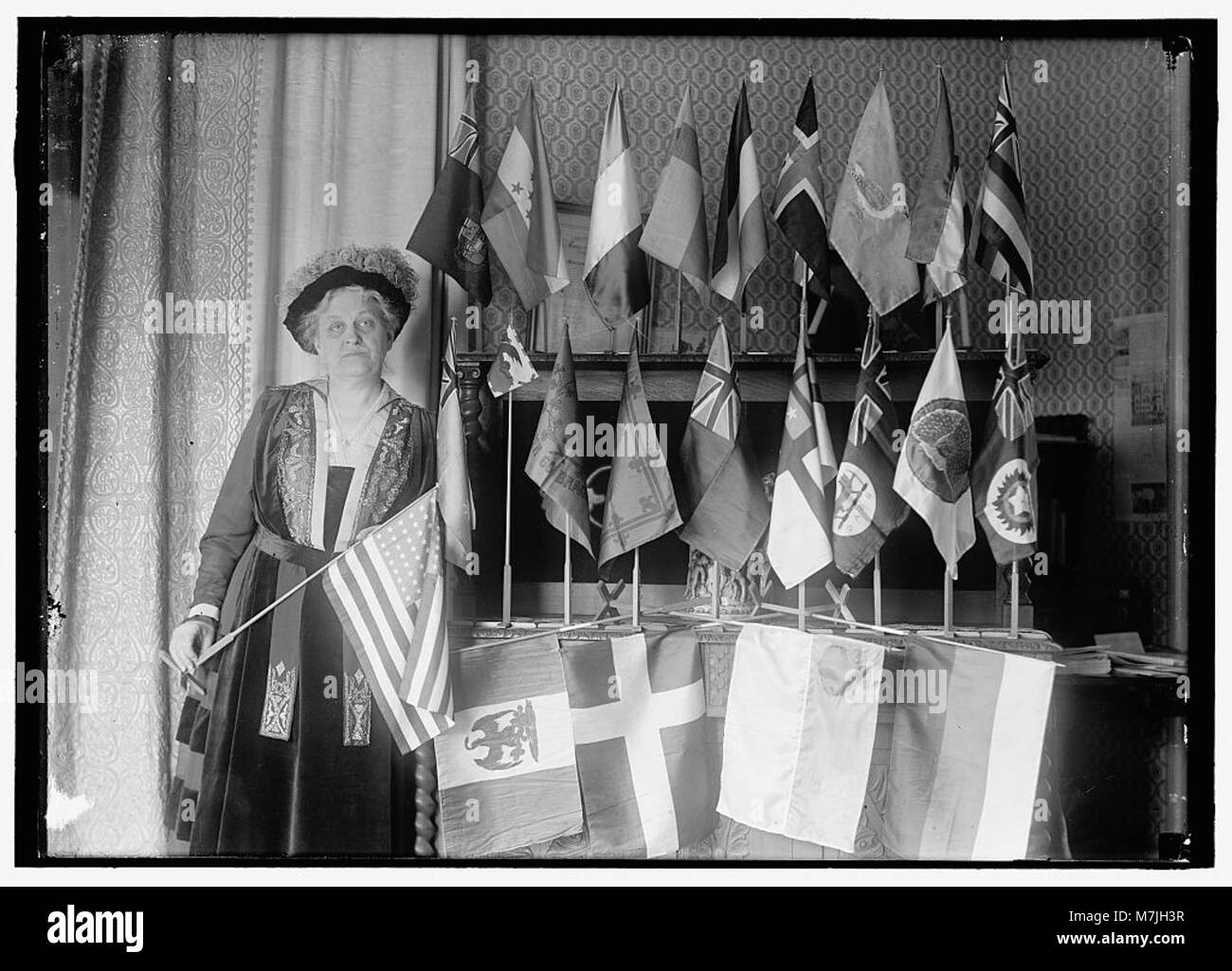 Carrie Chapman Catt, a prominent suffragist, holding flags of 22 ...