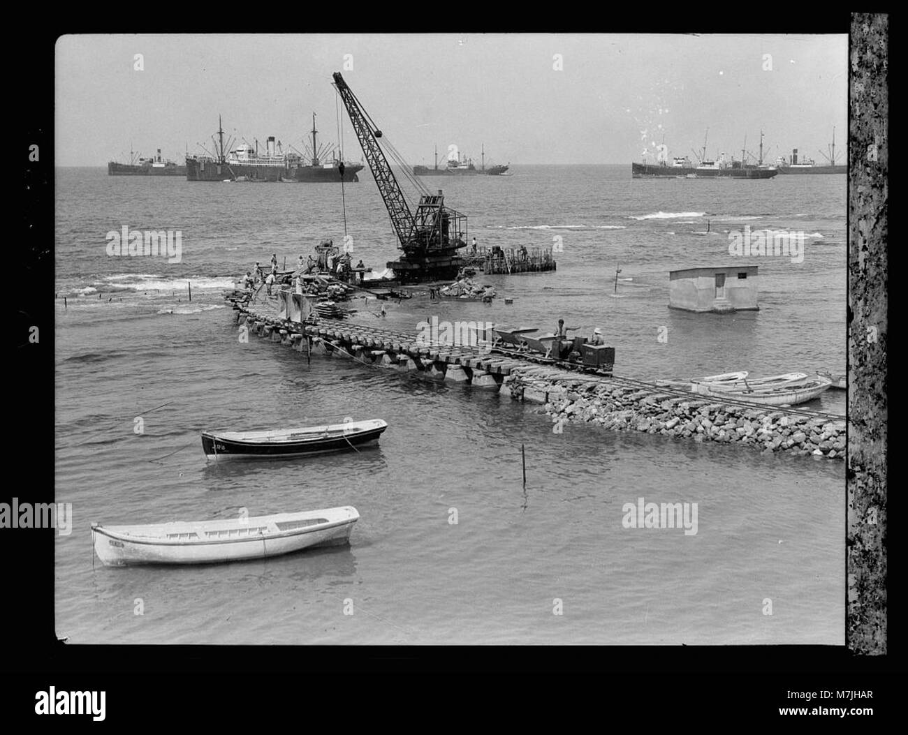 The image captures the ongoing construction of Jaffa pier, with a ...