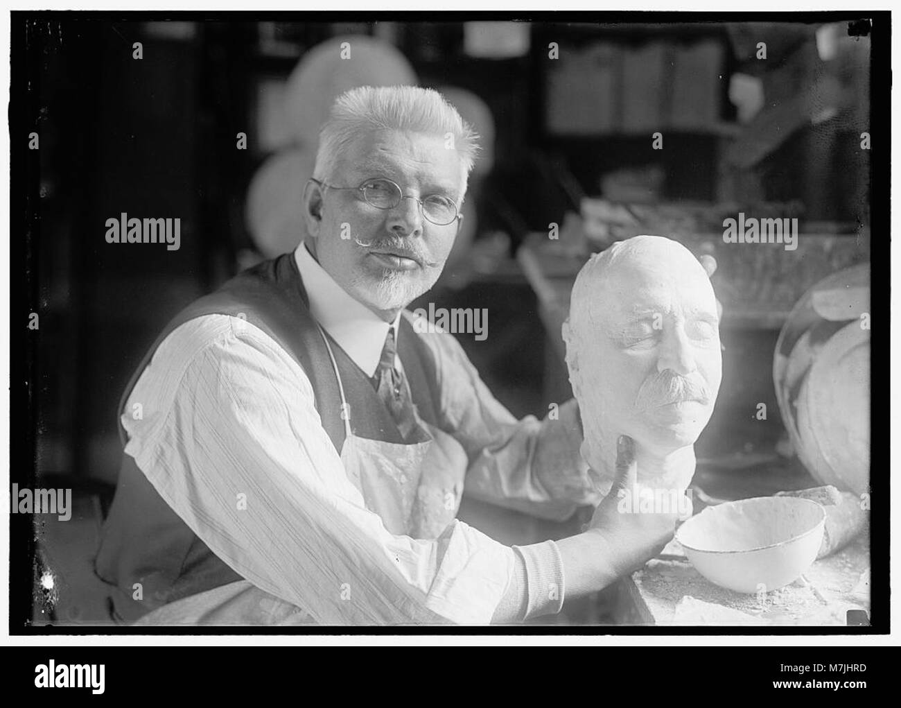 A photograph of U.S. Jay Dunbar with the death mask of Admiral Dewey ...