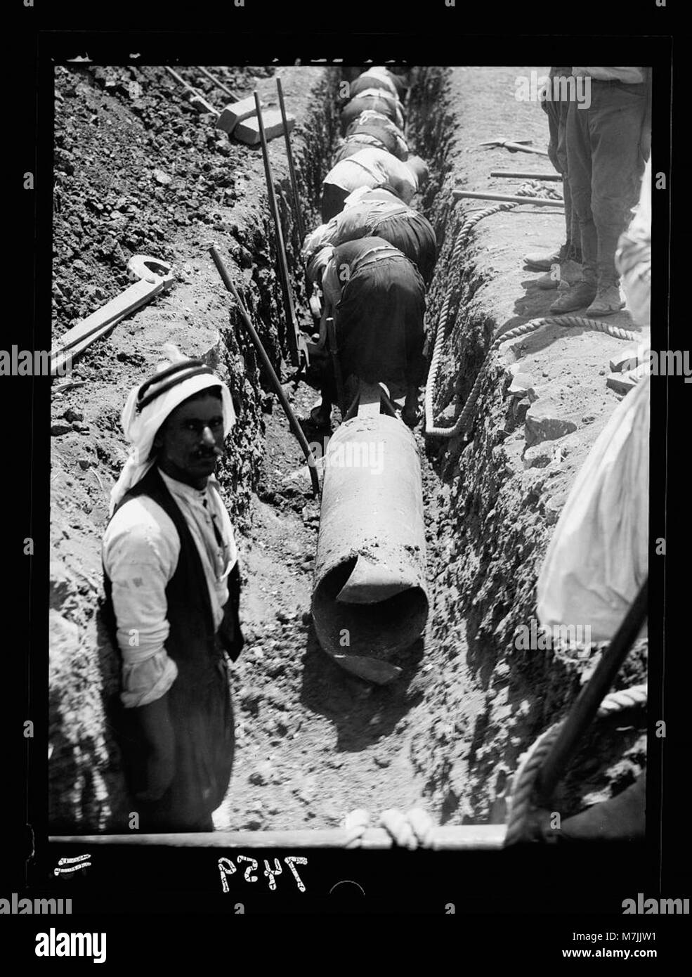 Photograph showing men working on a pipeline for the Iraq Petroleum ...
