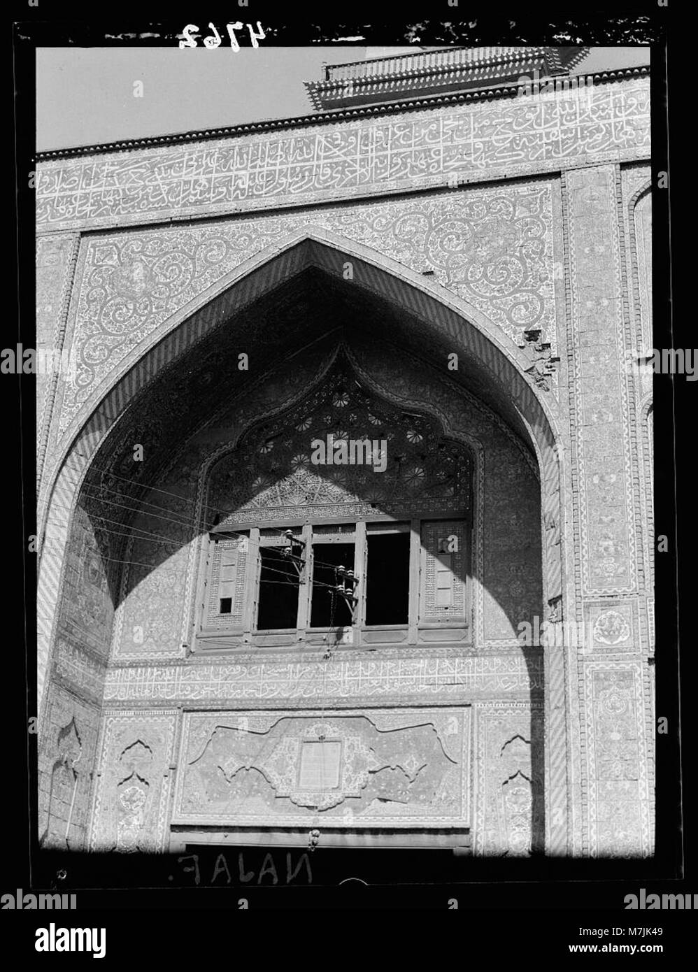 This image shows the entrance of a mosque in Najaf, Iraq, a sacred city ...