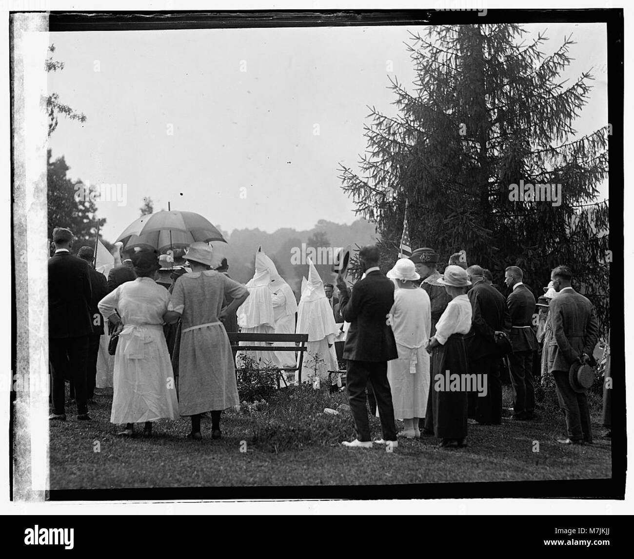A somber image depicting a funeral associated with the Ku Klux Klan ...