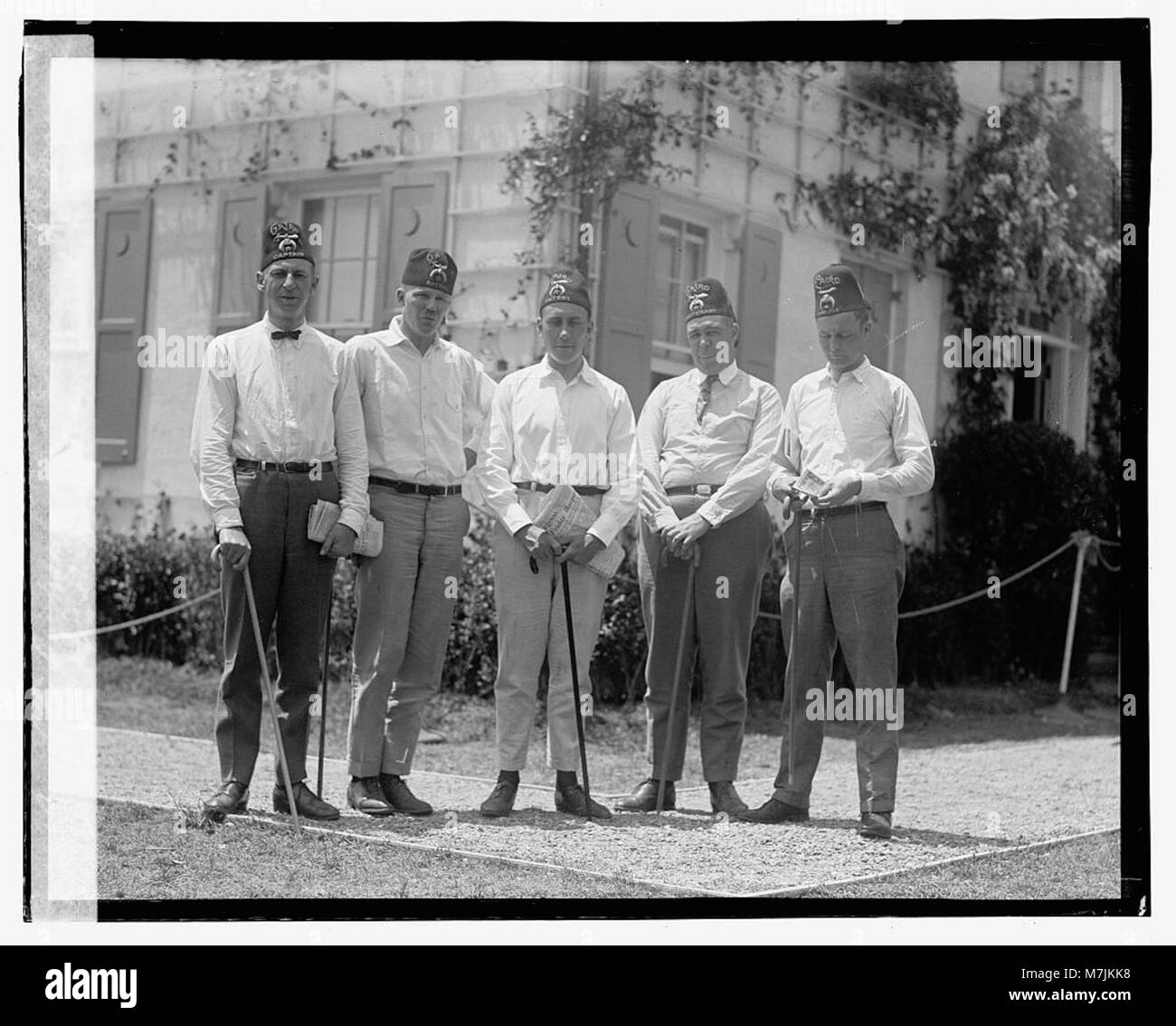 This historical photograph captures the individuals L.E. Lockerby ...