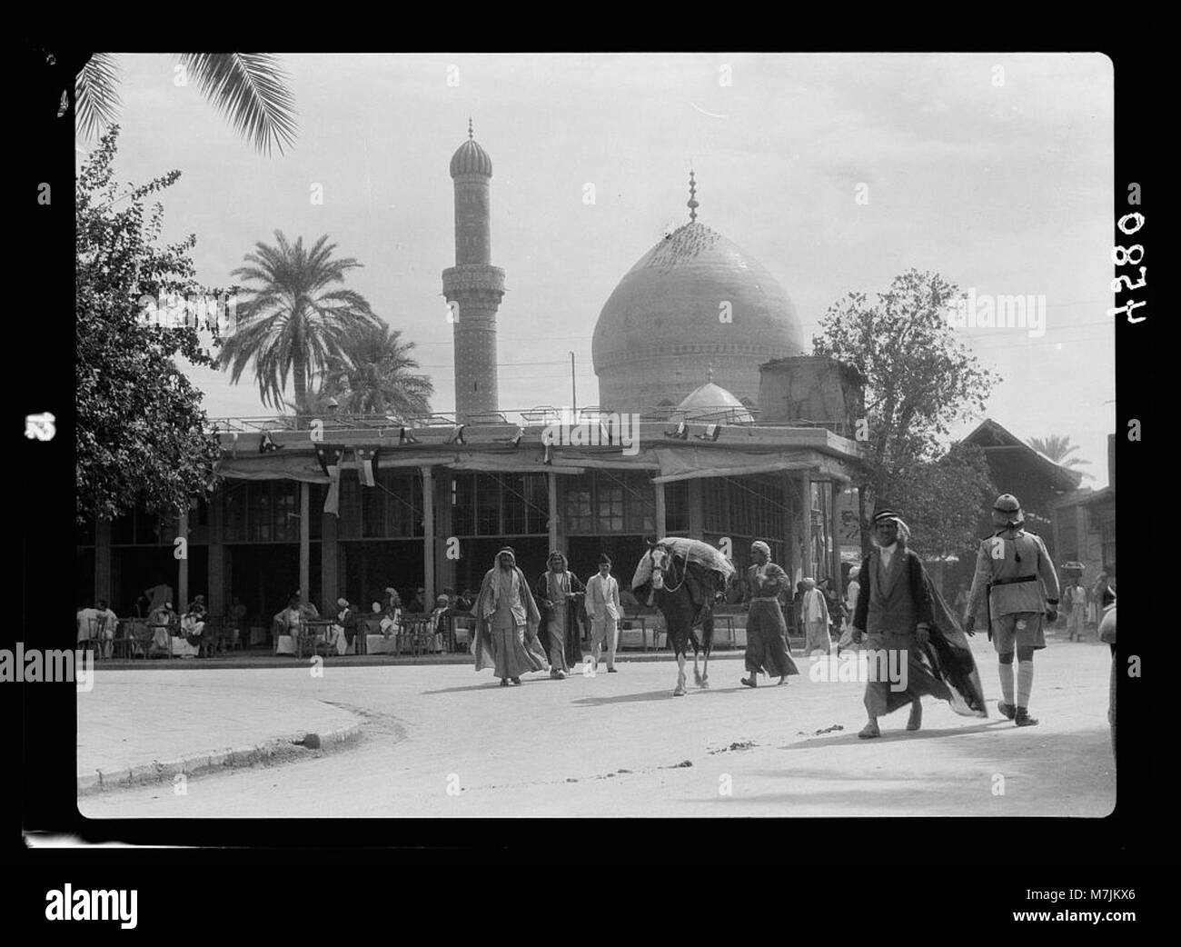 A street scene in Baghdad, Iraq, featuring the Midan mosque in the ...