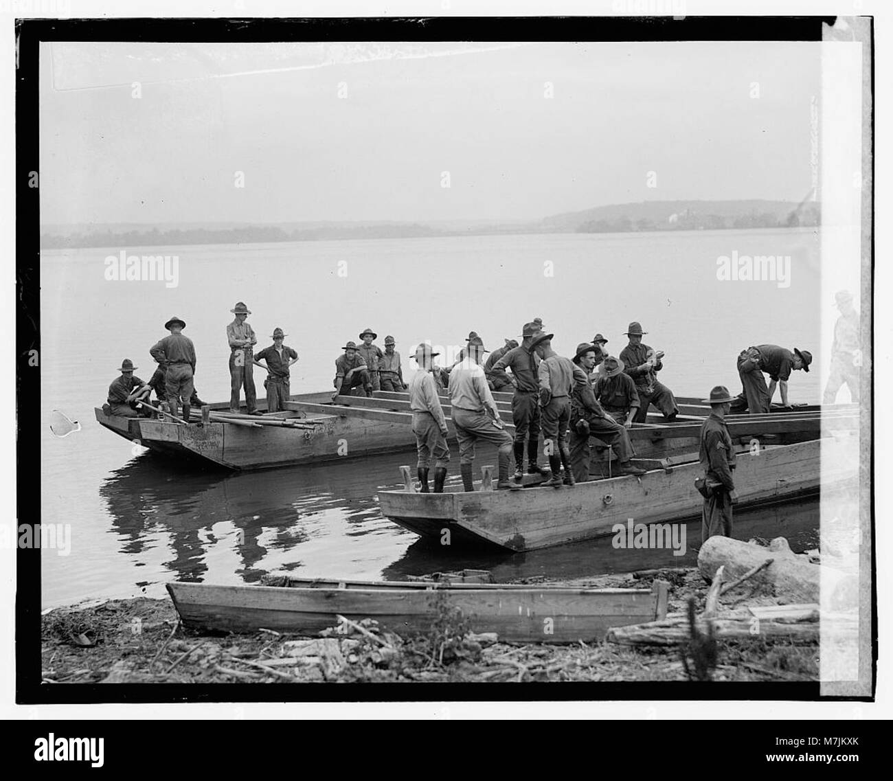 U.S. Marines are shown constructing pontoon bridges. This image ...