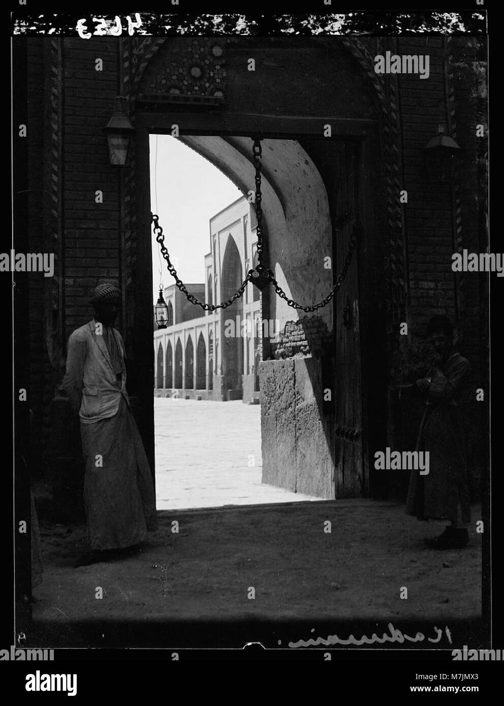 The image shows the entrance to the Great Mosque in Kadimain, Iraq, a ...