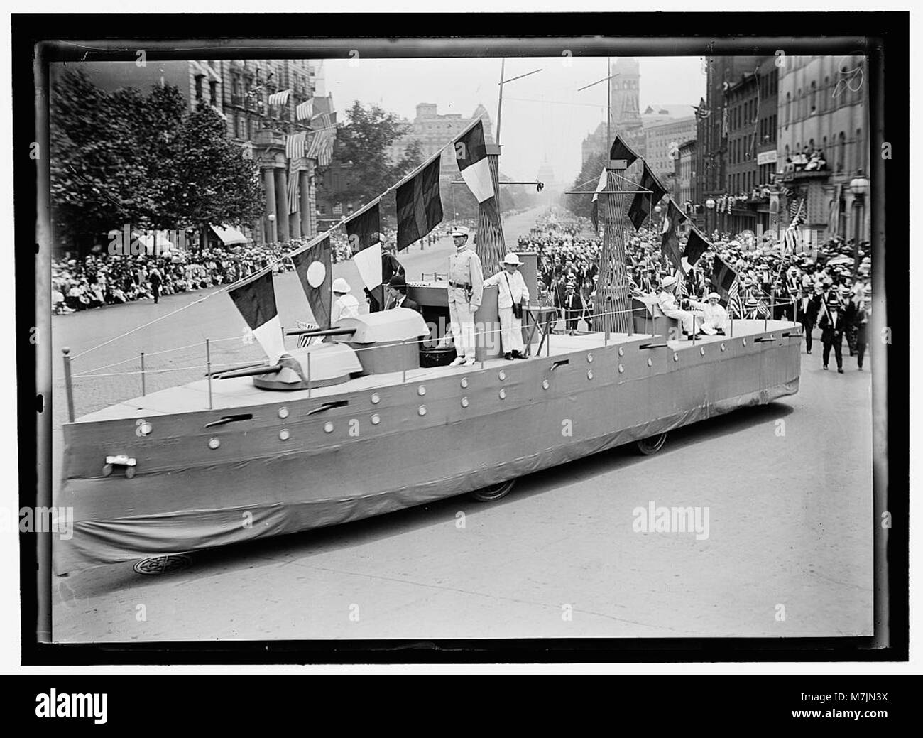 This image captures a float designed to resemble a battleship in a ...