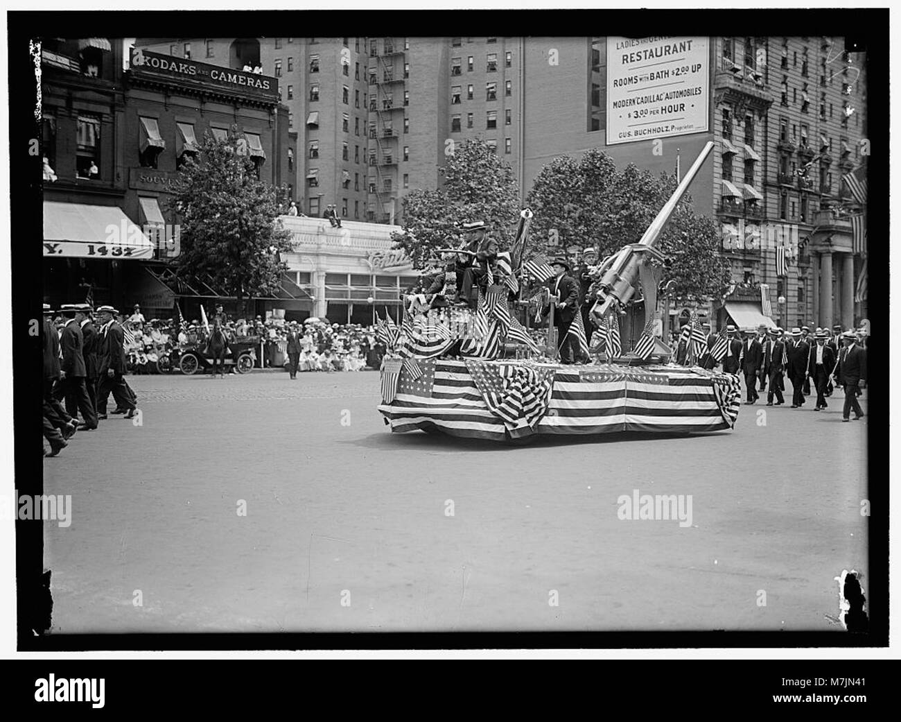 A historical image of a float featuring guns during a preparedness ...