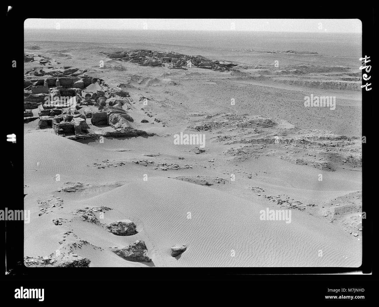 A photograph from the ruins of Ur in Iraq, showing sand encroaching on ...