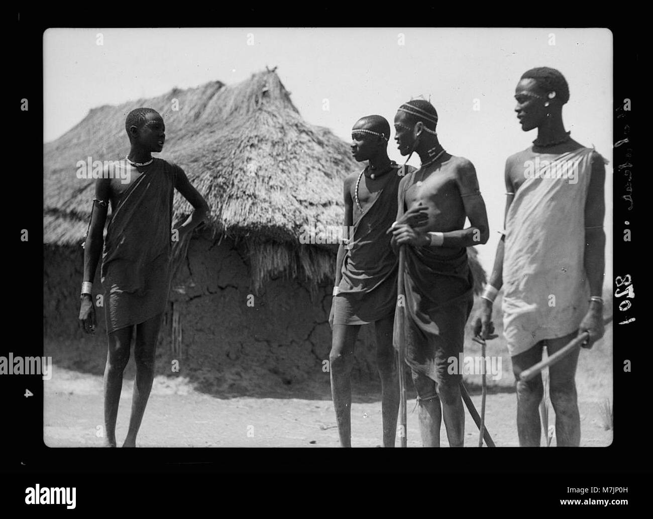 A photograph of Shiluk people in Malakal, Sudan, standing before a ...