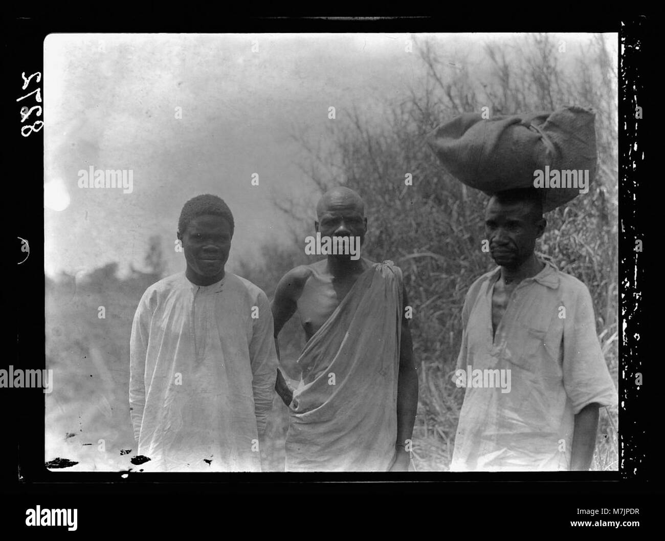 The image depicts three men from Uganda, traveling between Hoima and ...
