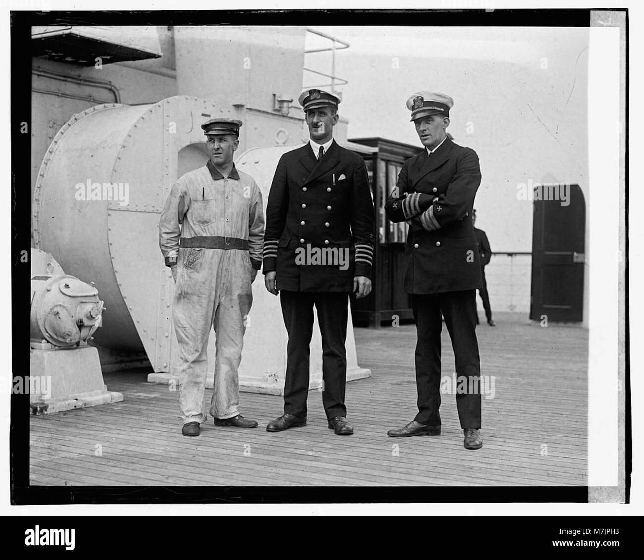 This photograph shows a group of unidentified men aboard a ship ...
