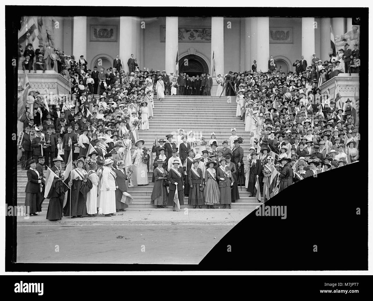 The image depicts a woman suffrage event at the U.S. Capitol ...