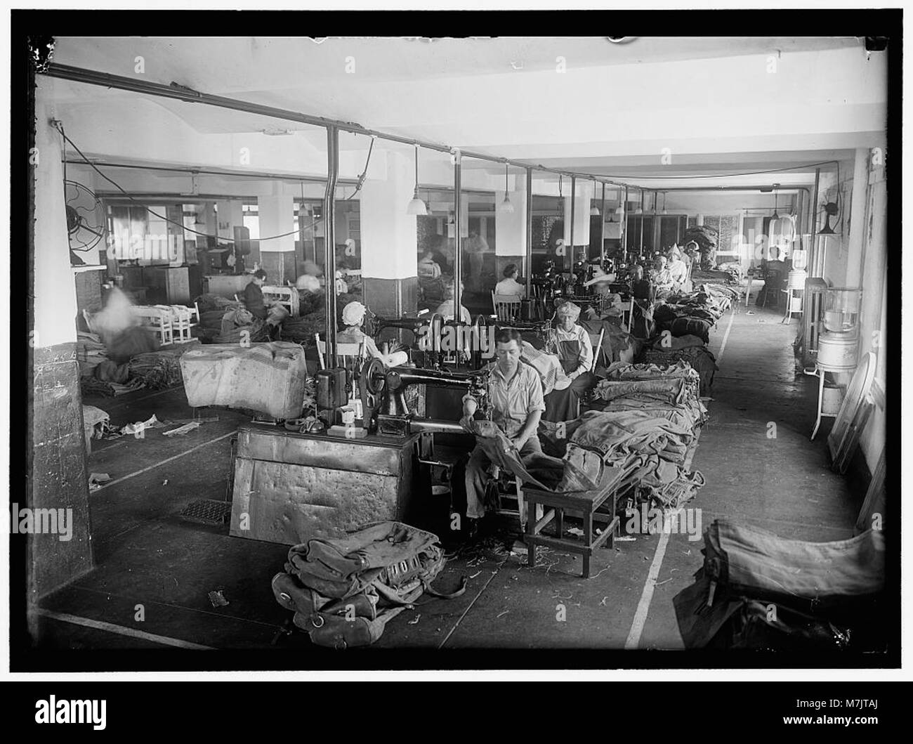An image depicting workers repairing mailbags, illustrating the ...