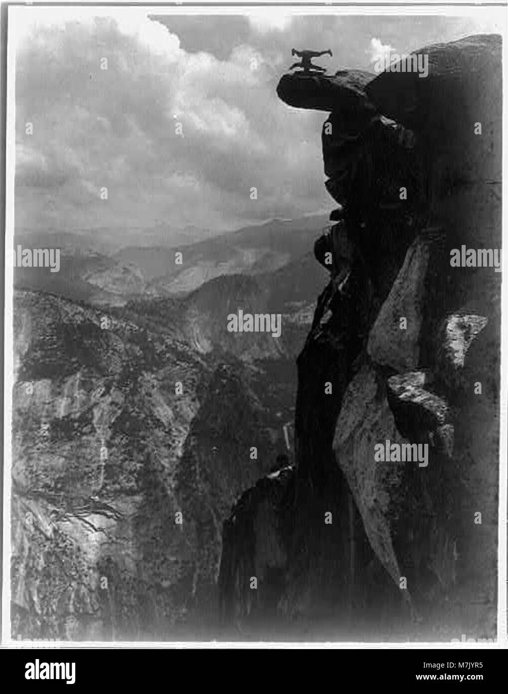 This photograph shows a person balancing an object on their head, a ...