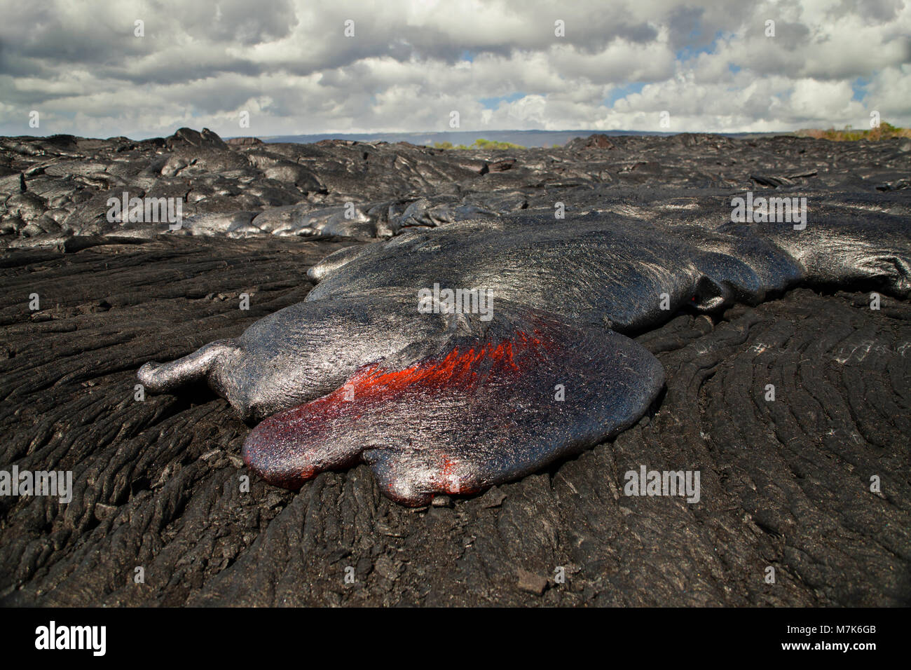 This new Pahoehoe lava flowing from Kilauea is covering an older ...