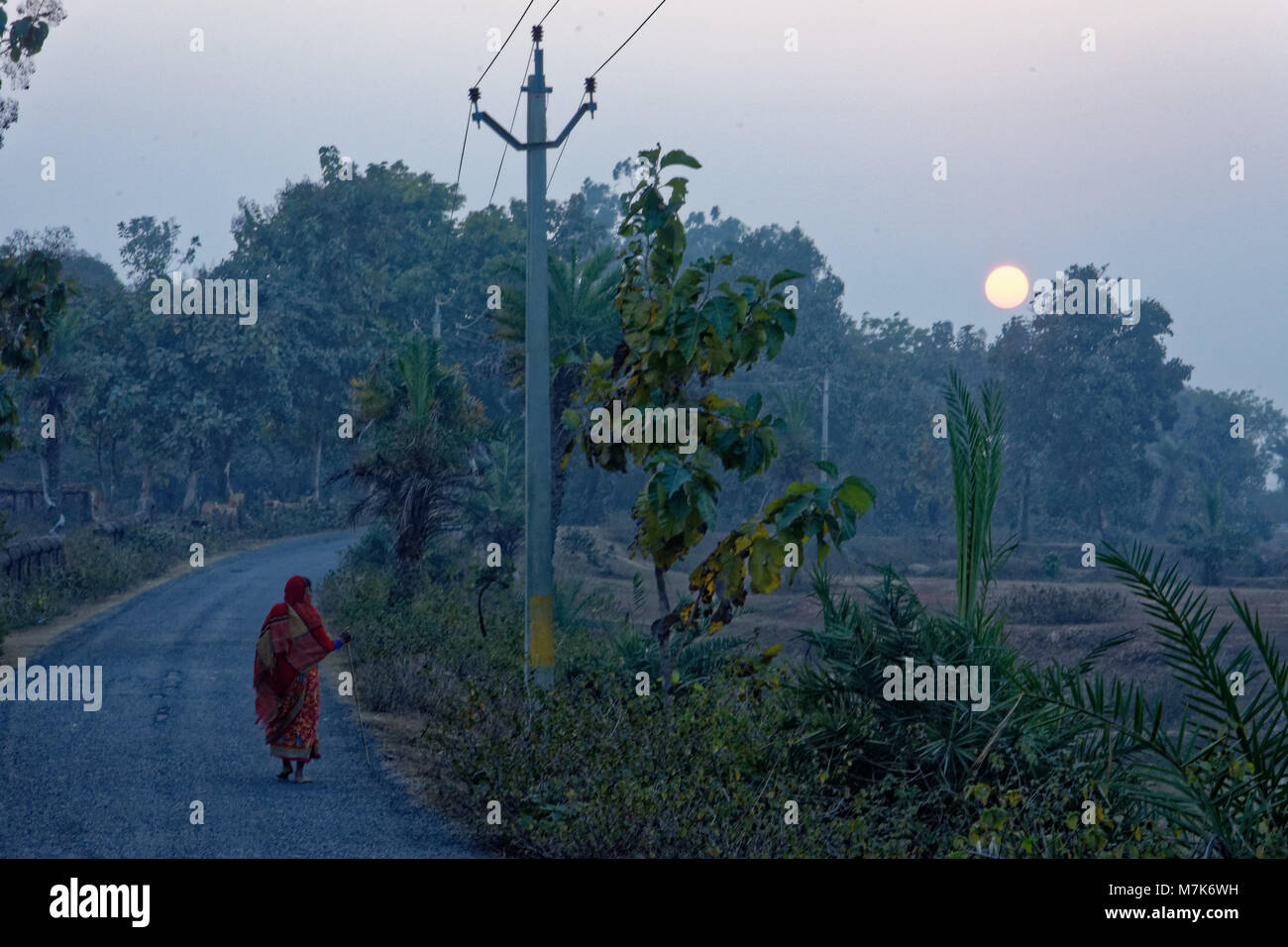 rural woman going home at the time of sunset Stock Photo - Alamy