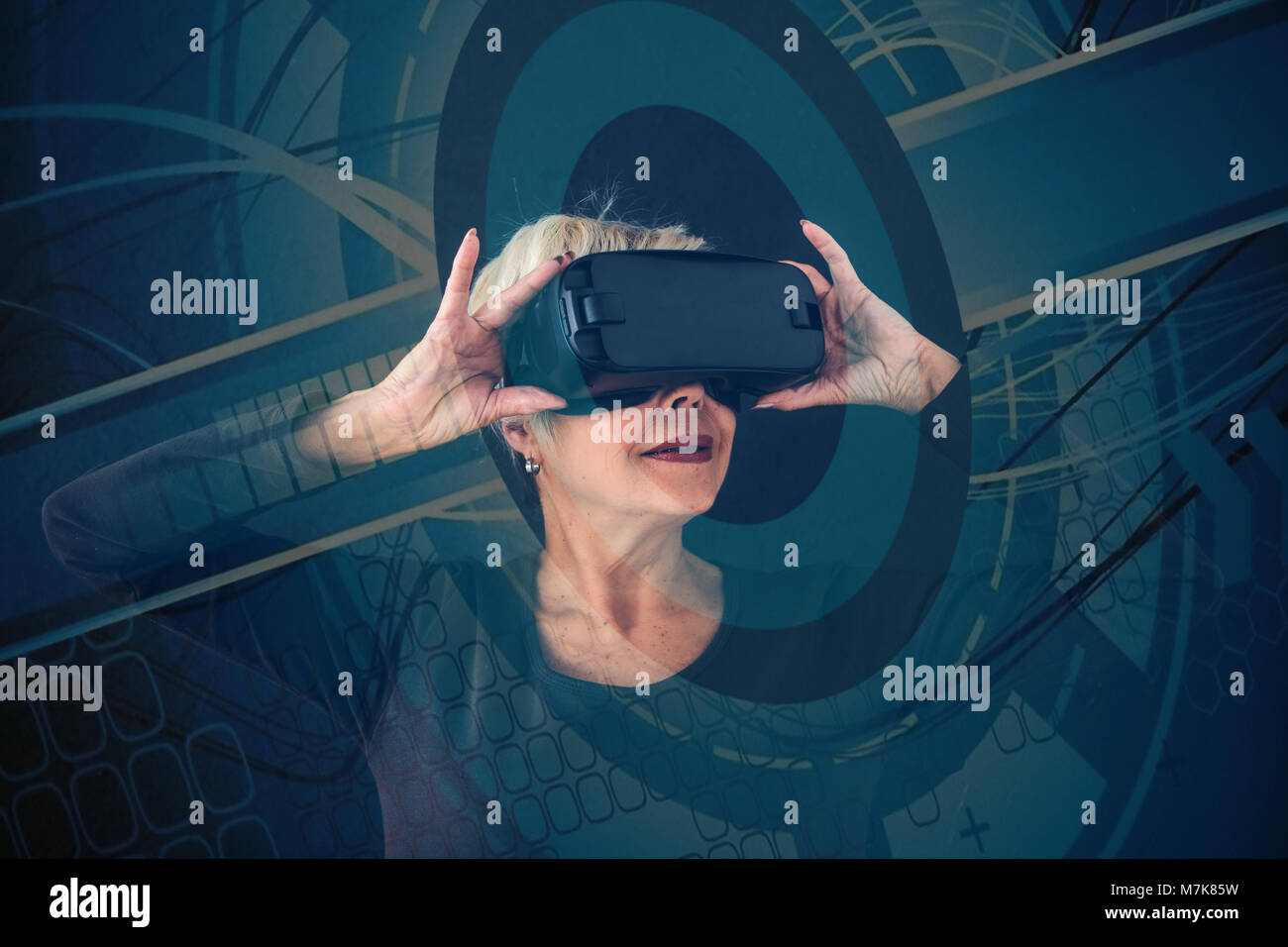 An elderly woman in virtual reality glasses. With visual effects. An ...