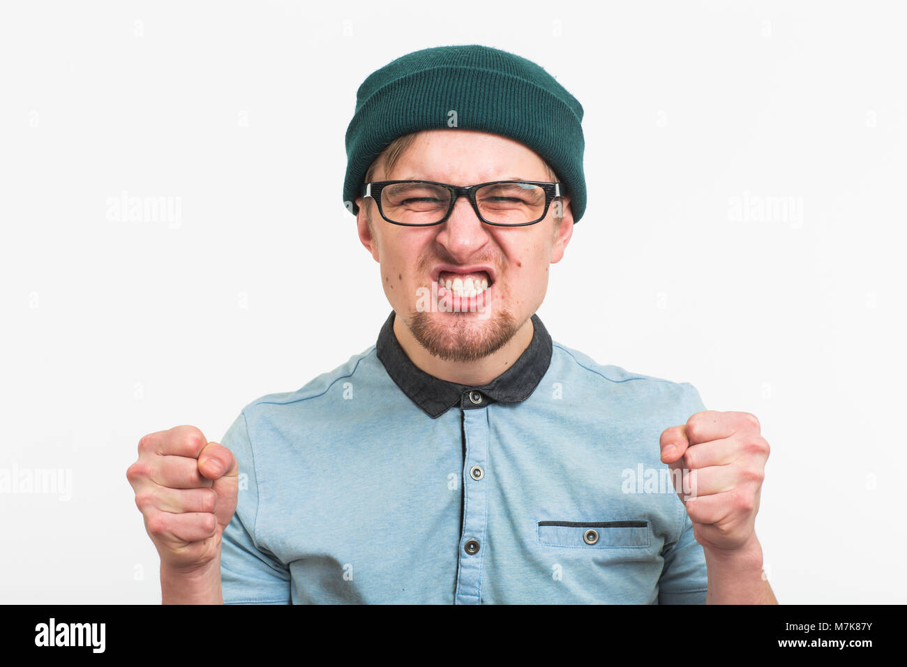 Angry aggressive man with ferocious expression on white background ...