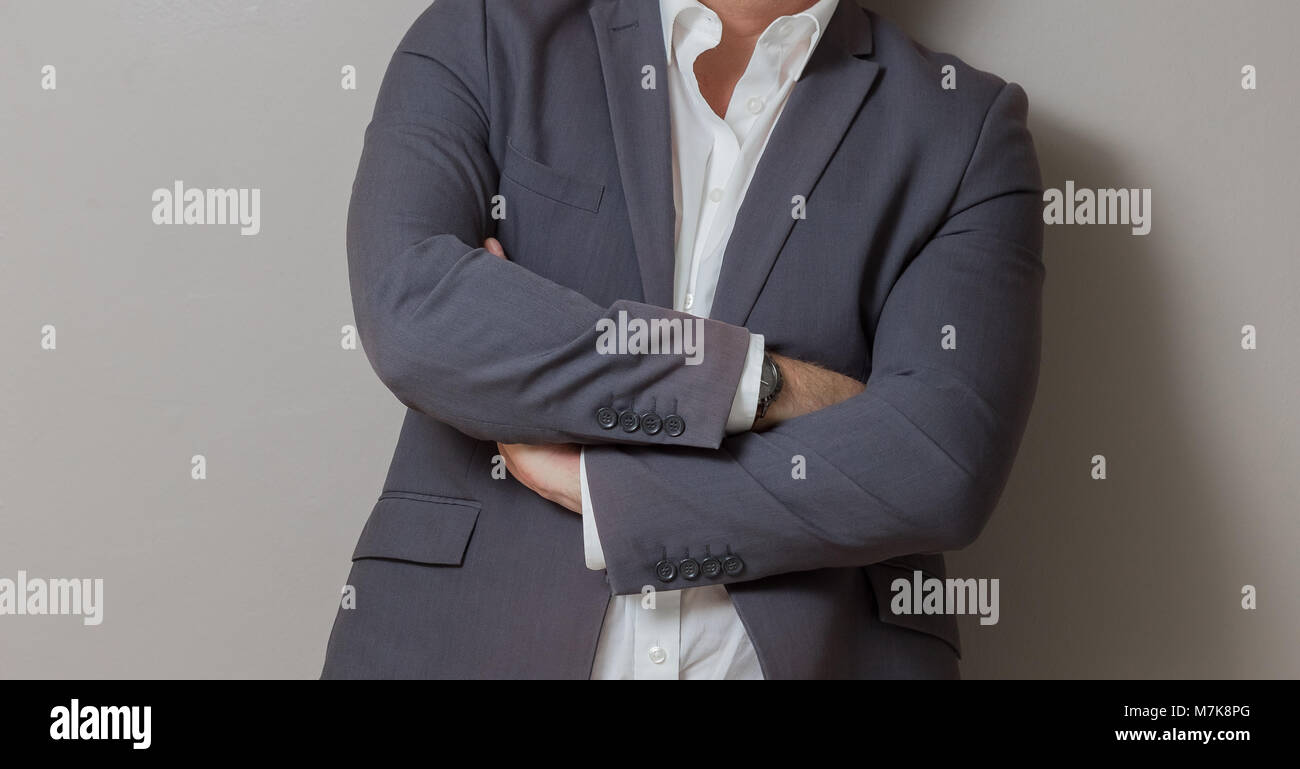 Young man suit grey arms folded hi-res stock photography and images - Alamy