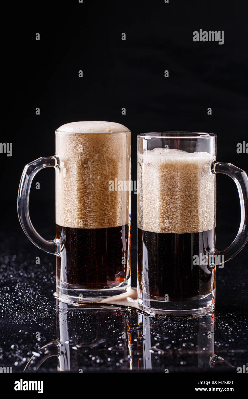 Two mugs of frothy beer Stock Photo - Alamy