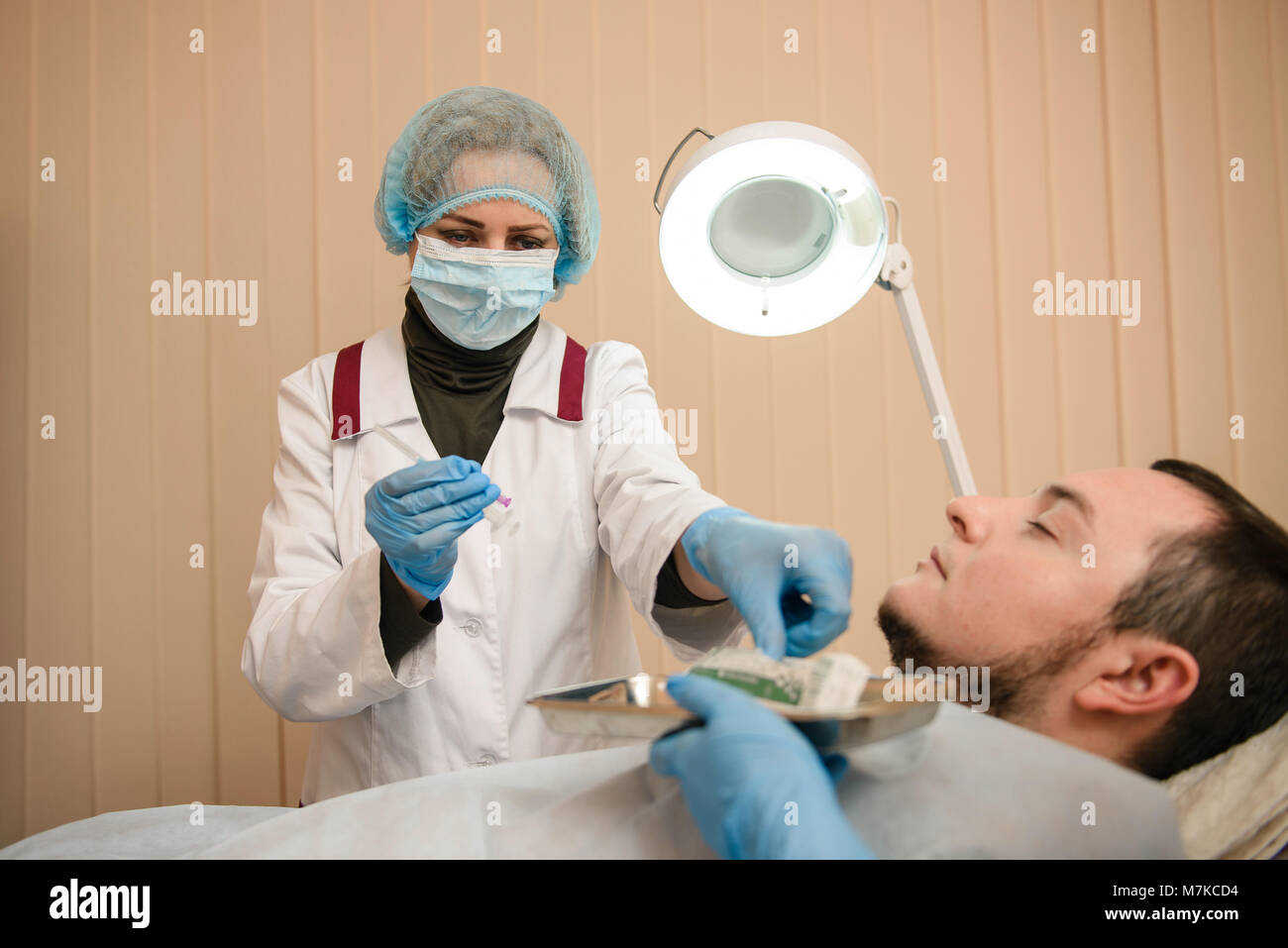 Woman doctor make medical face check and treatment. Doctor takes a ...