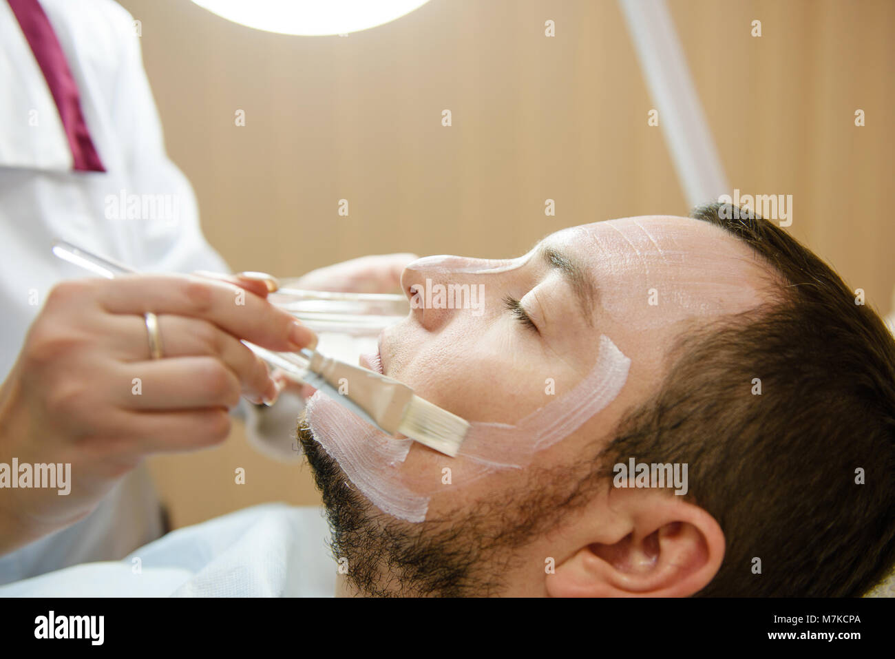 Male patient get facial treatment in hospital. Face mask for man in ...