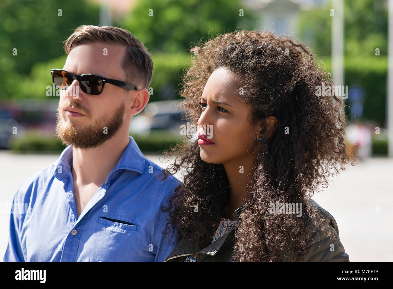 Young multiracial couple look serious and frightened as diversity ...