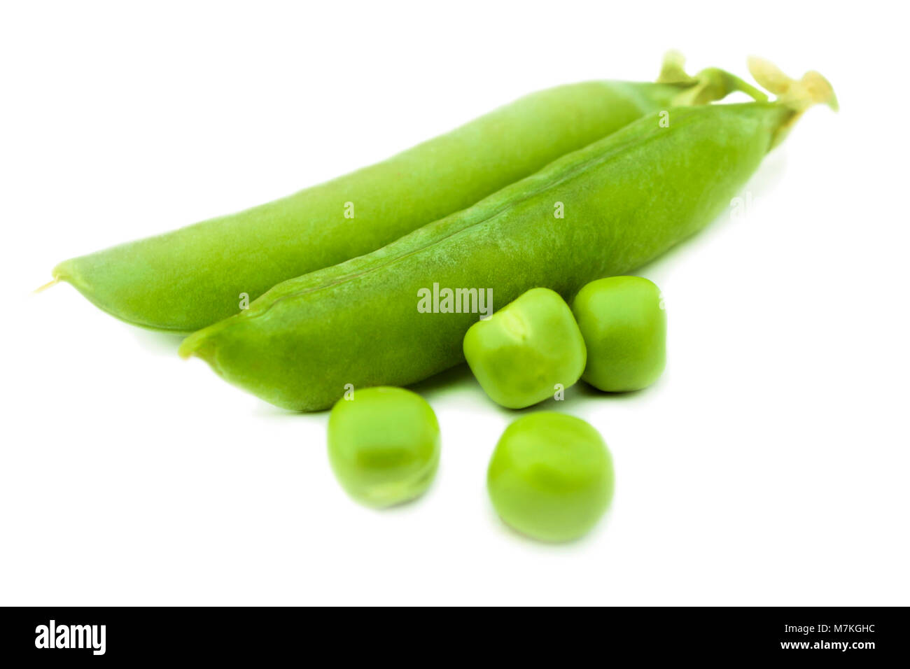 Two ripe pod and four peas isolated on white background Stock Photo - Alamy