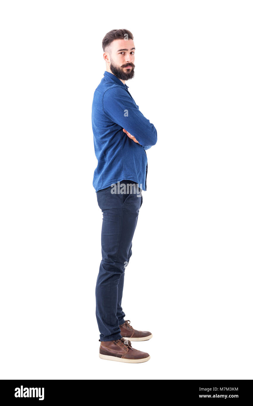 Side view of confident serious cool man with crossed arms looking at ...