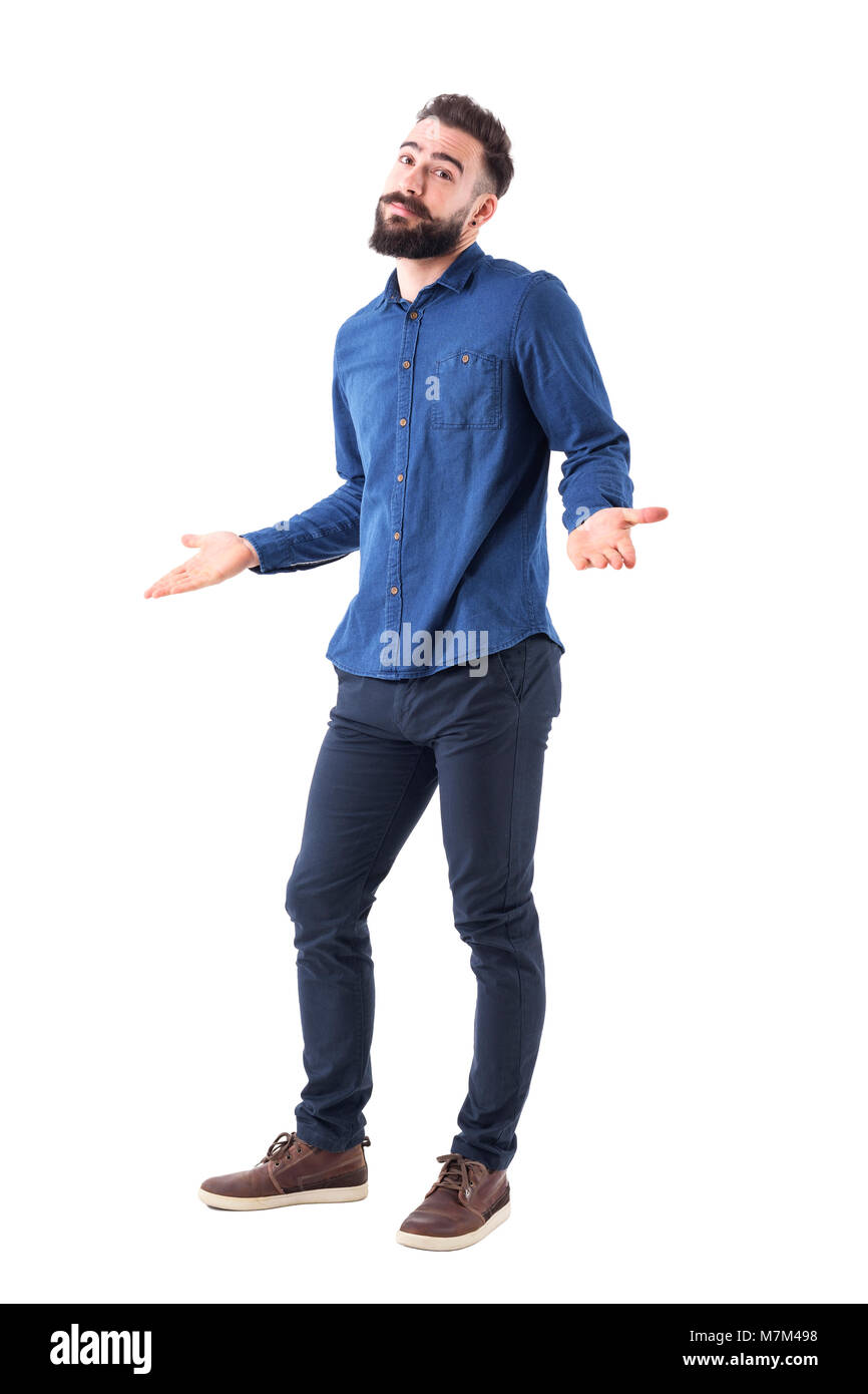 Puzzled confused man in blue shirt shrugging shoulders looking at ...