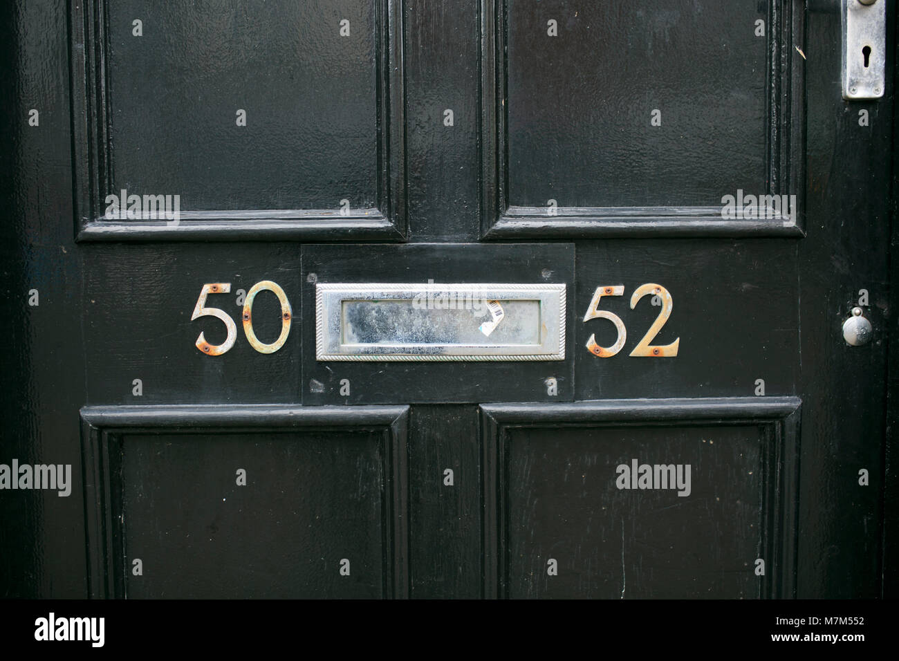 Address number in a wooden door Stock Photo - Alamy