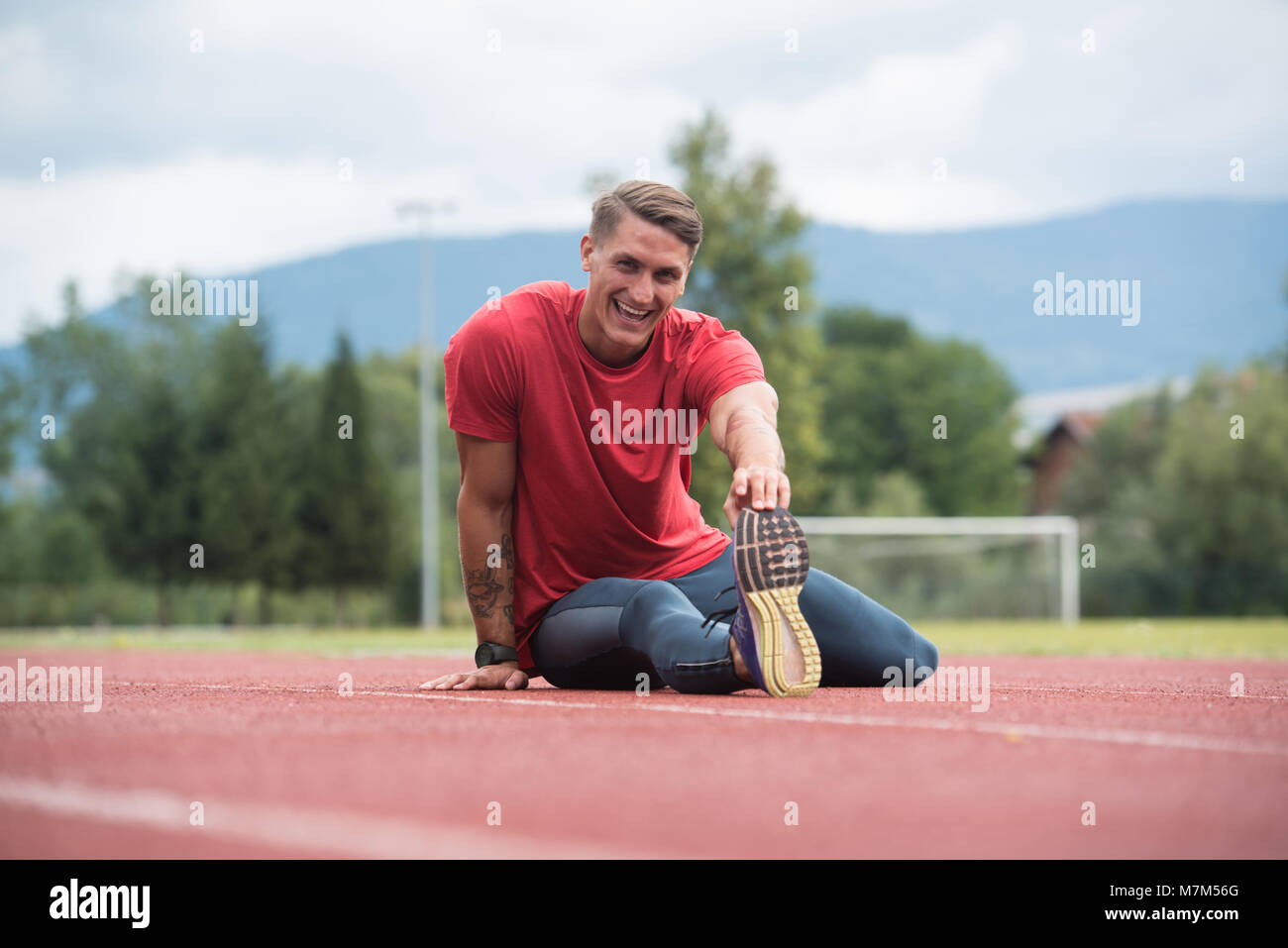 Young Athlete Man Relax and Strech Ready for Run at Athletics Race ...