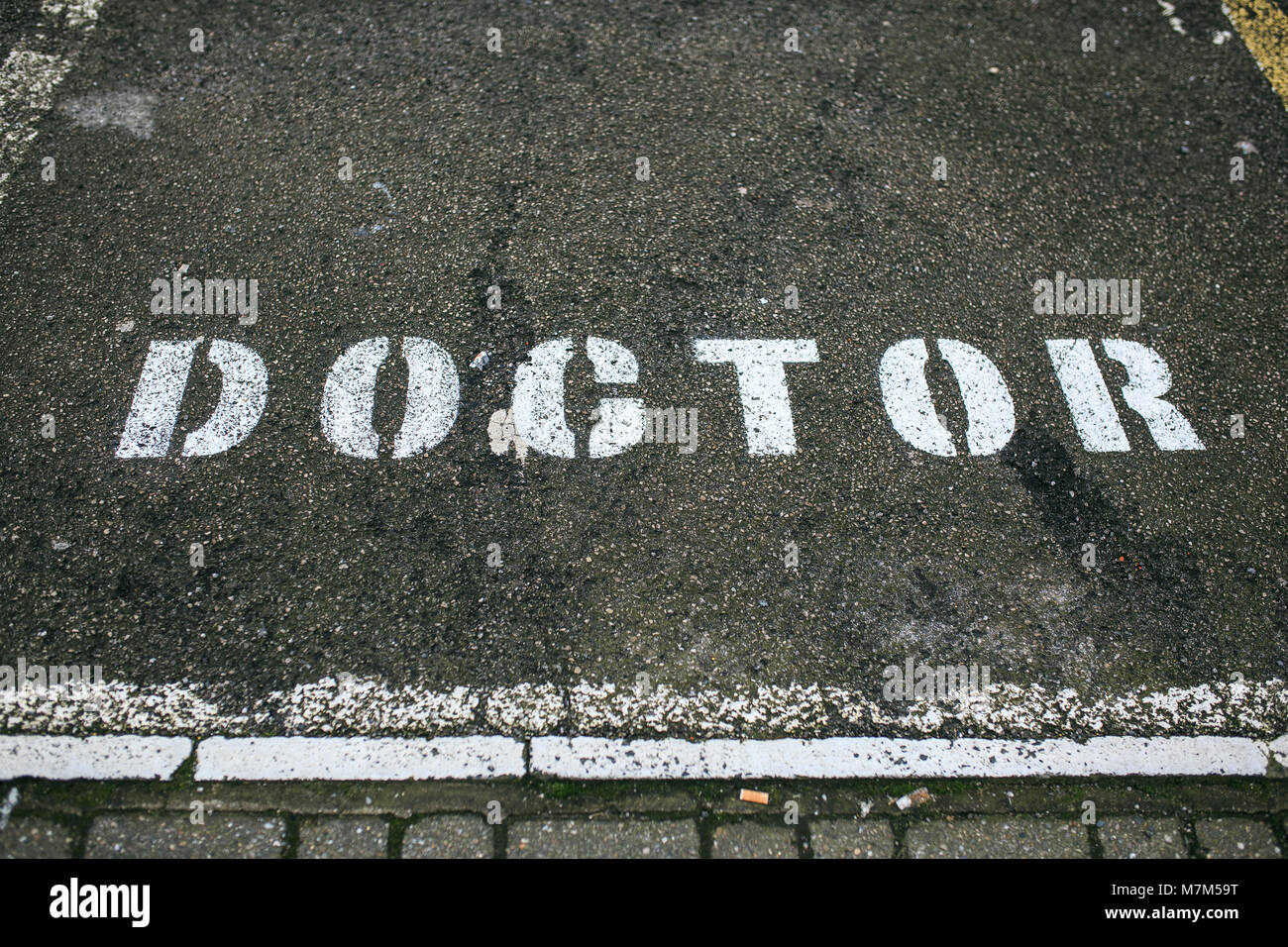 white doctor sign painted in a road Stock Photo - Alamy