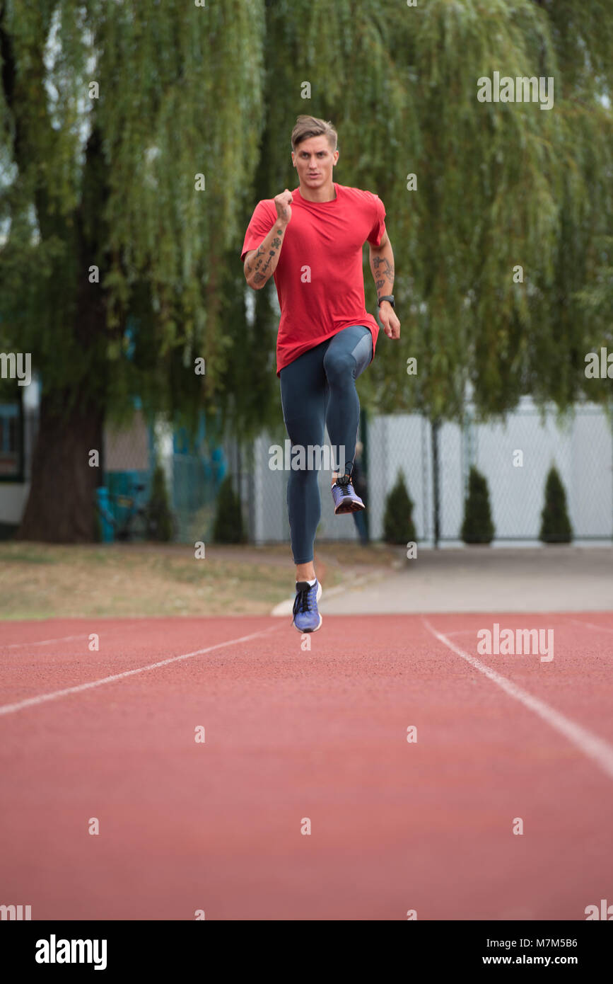 Sporty Man Running Fitness Workout on Track Exercising Outside Stock ...