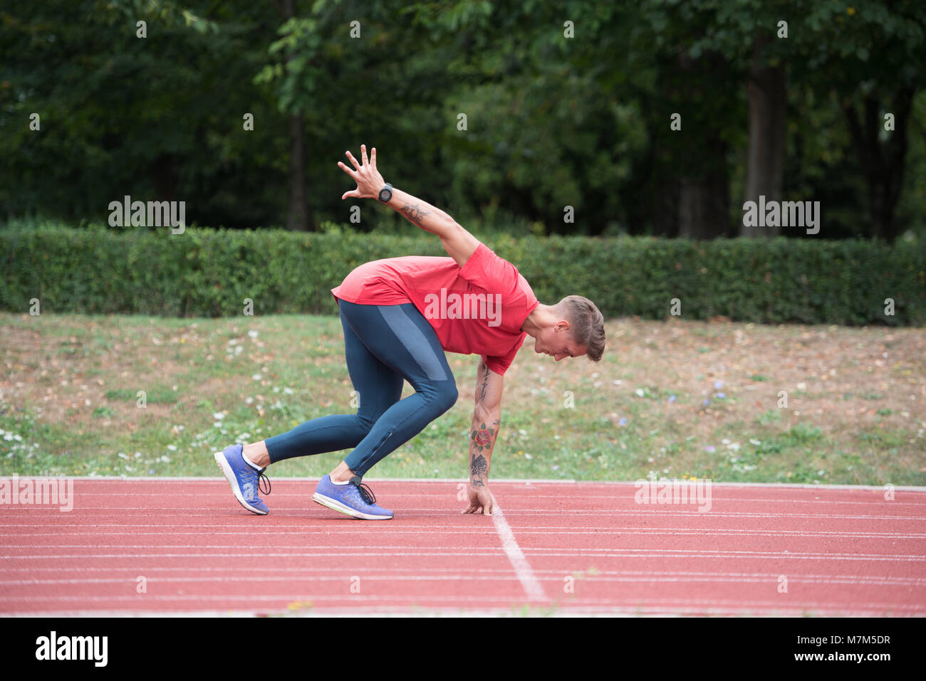 Sprinter Man Running on Red Tracks Lanes in Track and Field Stadium in ...